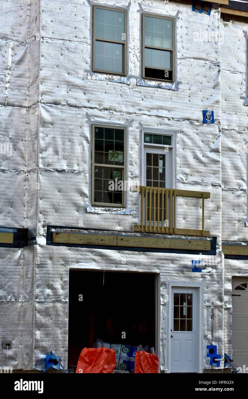 A new home construction site with new homes that are in the process of ...