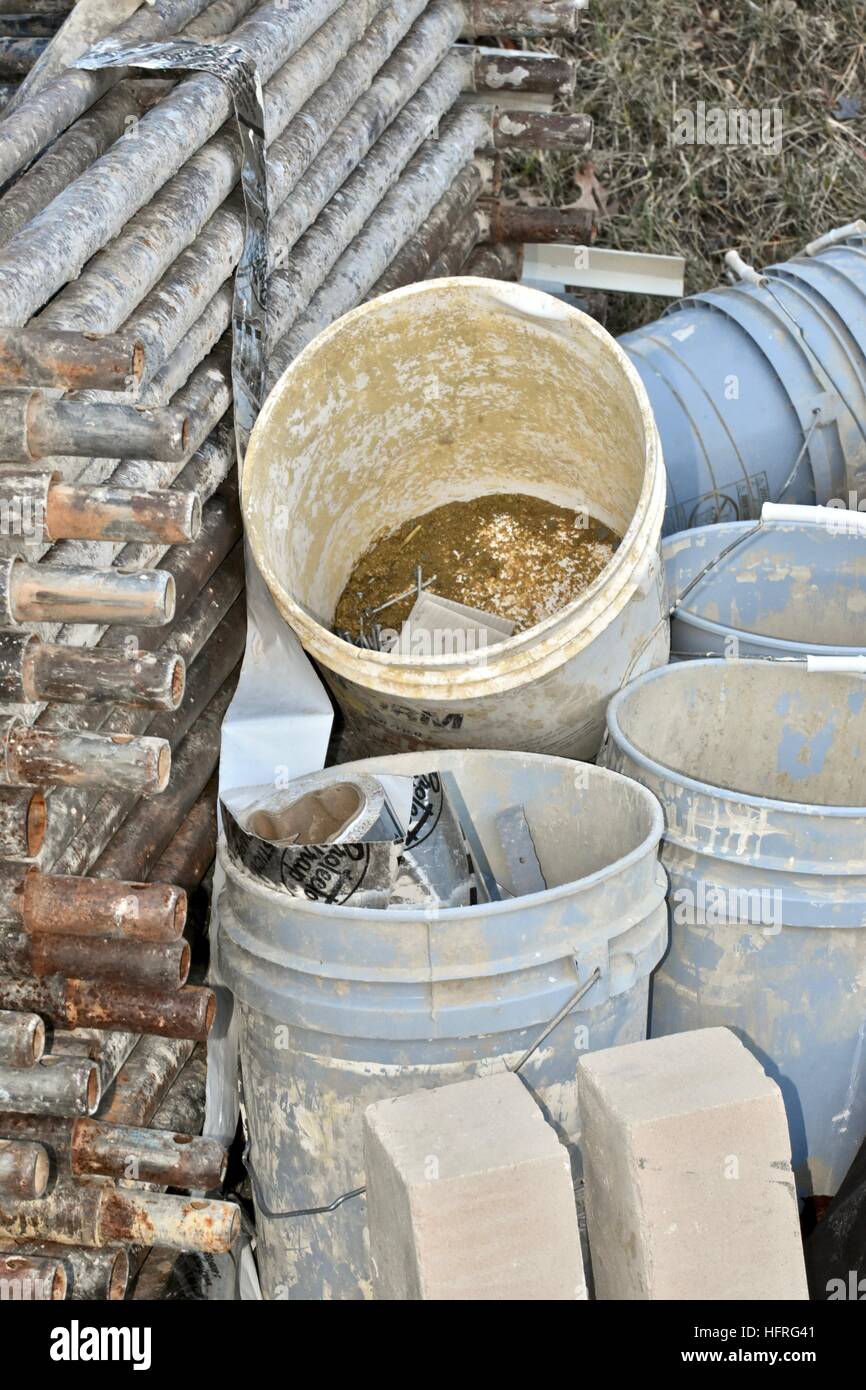 Construction equipment laying on the ground near a construction site ...