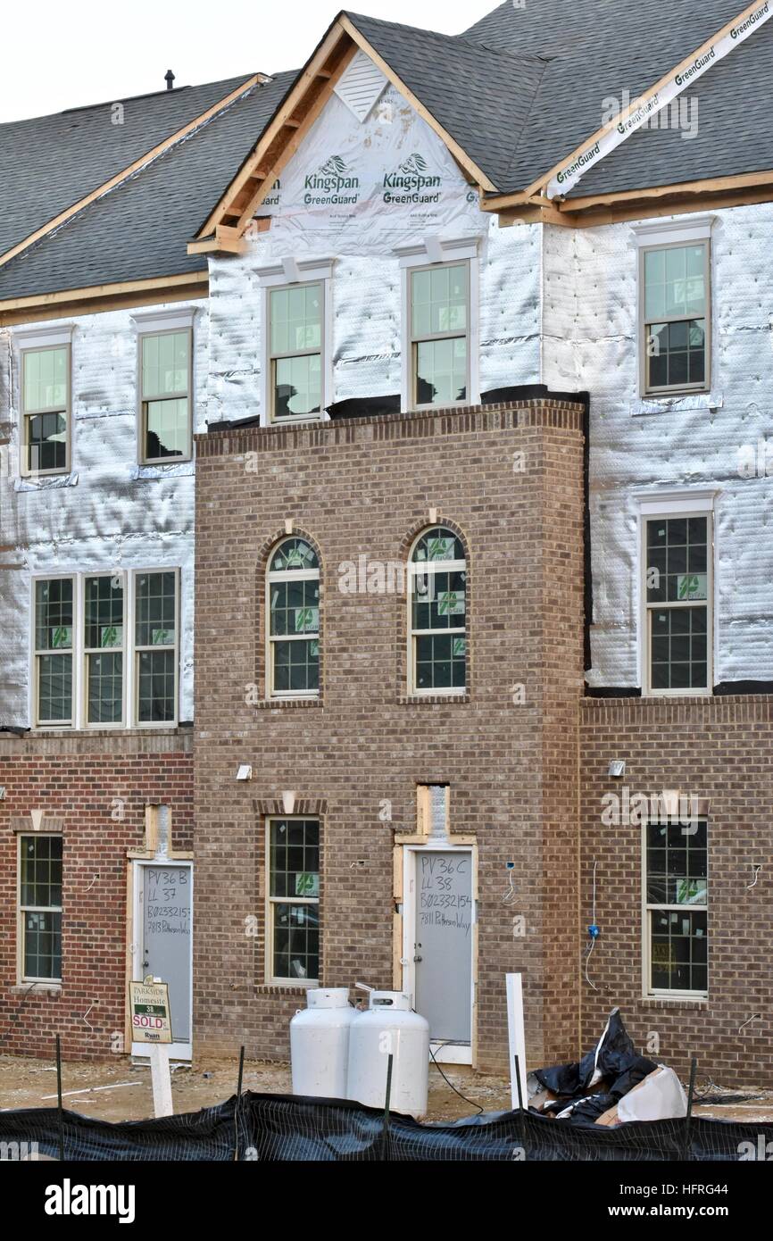 A new home construction site with new homes that are in the process of ...