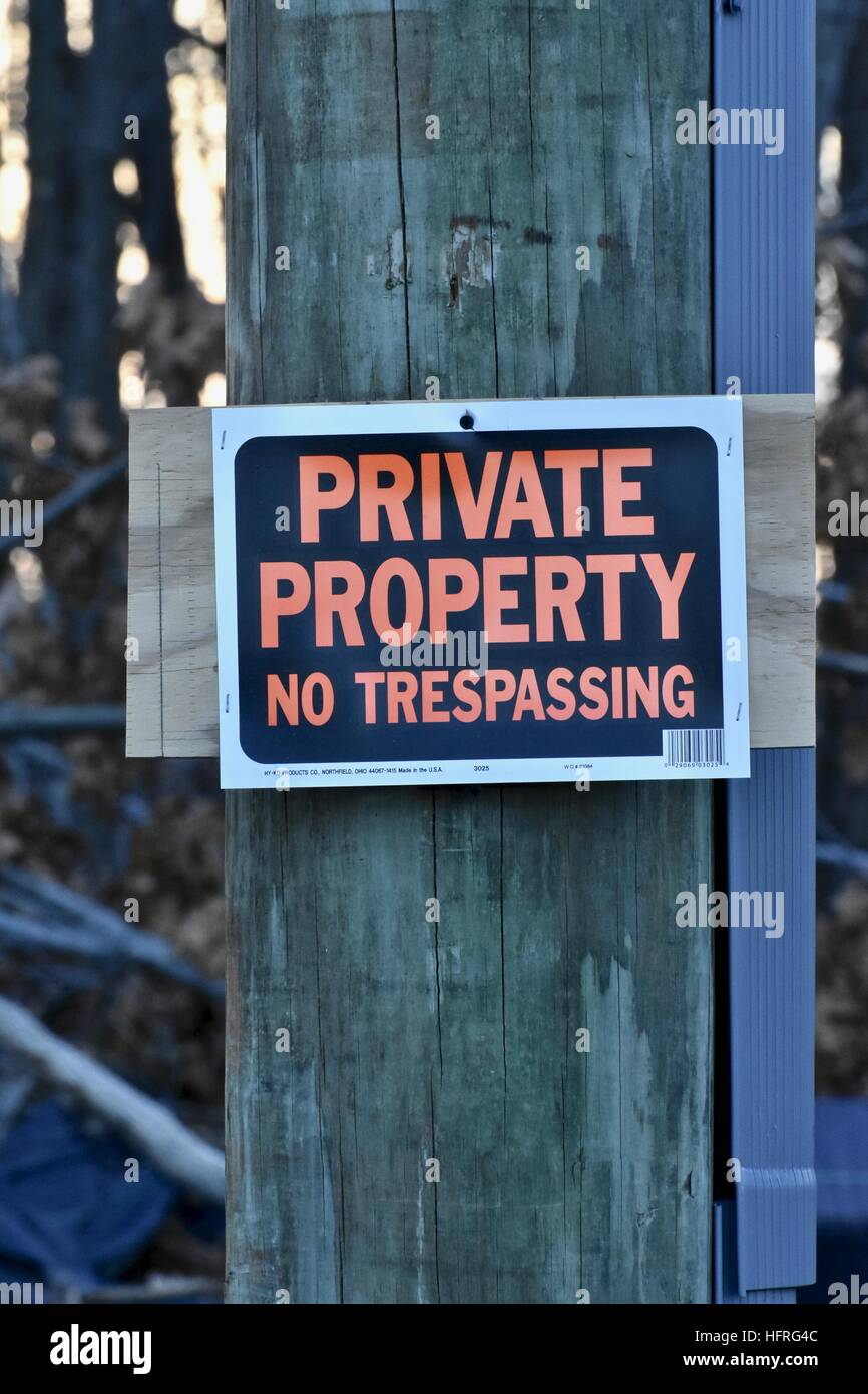 A private property sign posted on a street post at the end of a ...