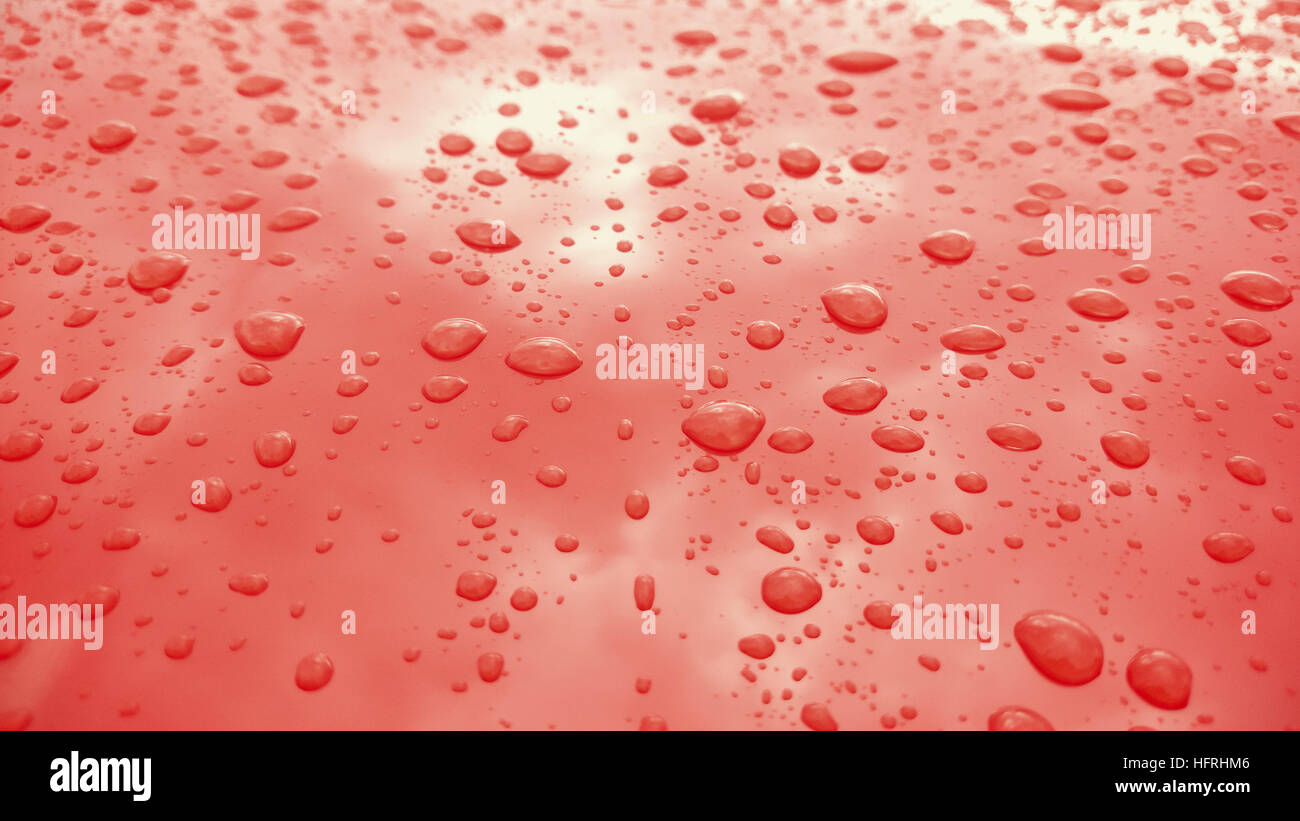 Rain drops on red background as background Stock Photo - Alamy