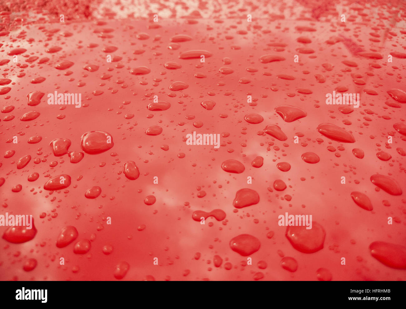 Rain drops on red background as background Stock Photo - Alamy