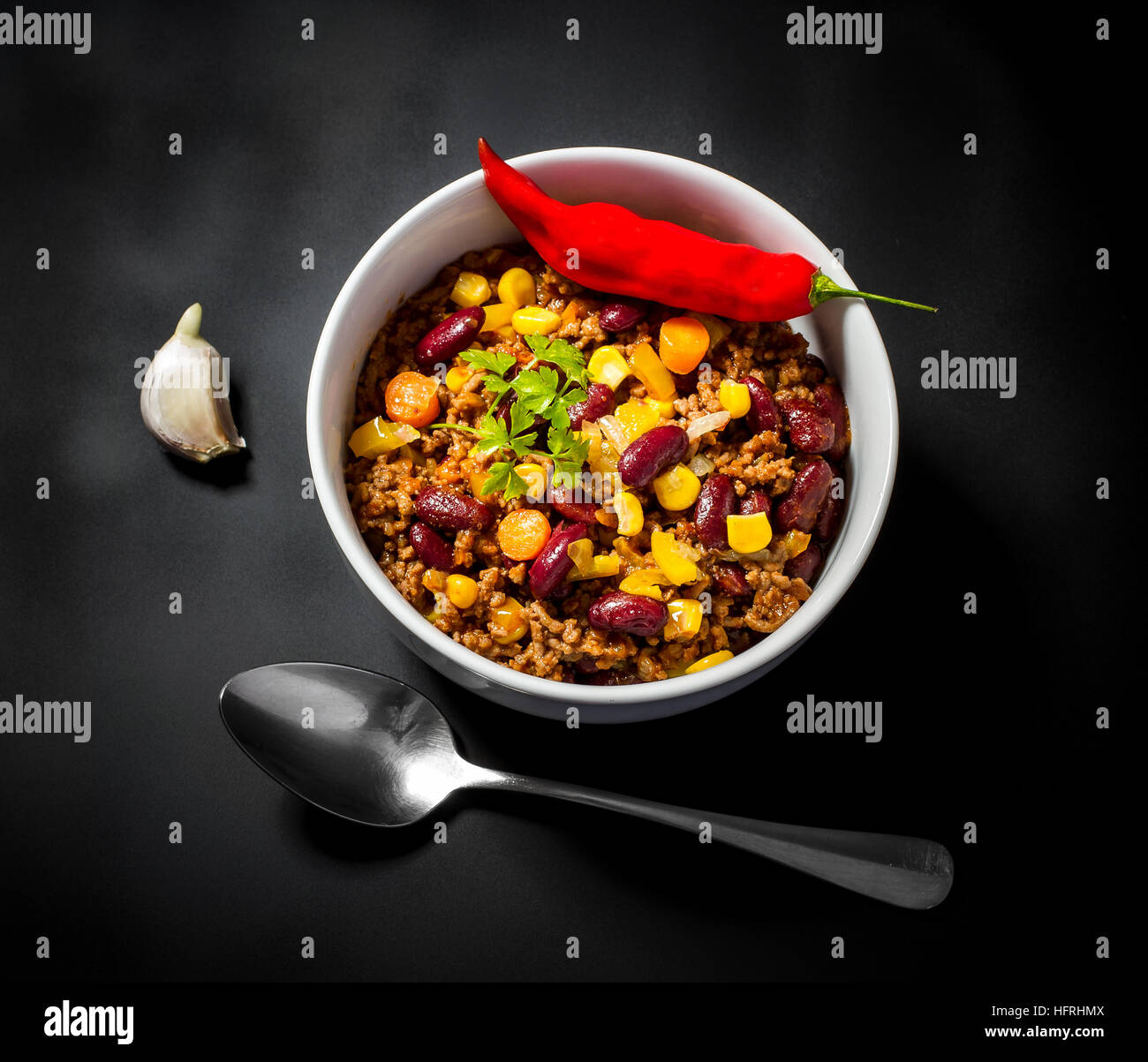 Chili con Carne on black, top view Stock Photo - Alamy