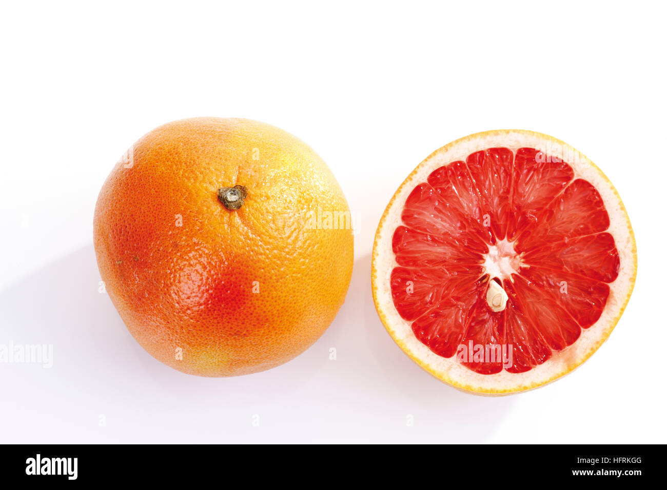 Ruby Red Grapefruits (Citrus x paradisi), whole and halved Stock Photo ...