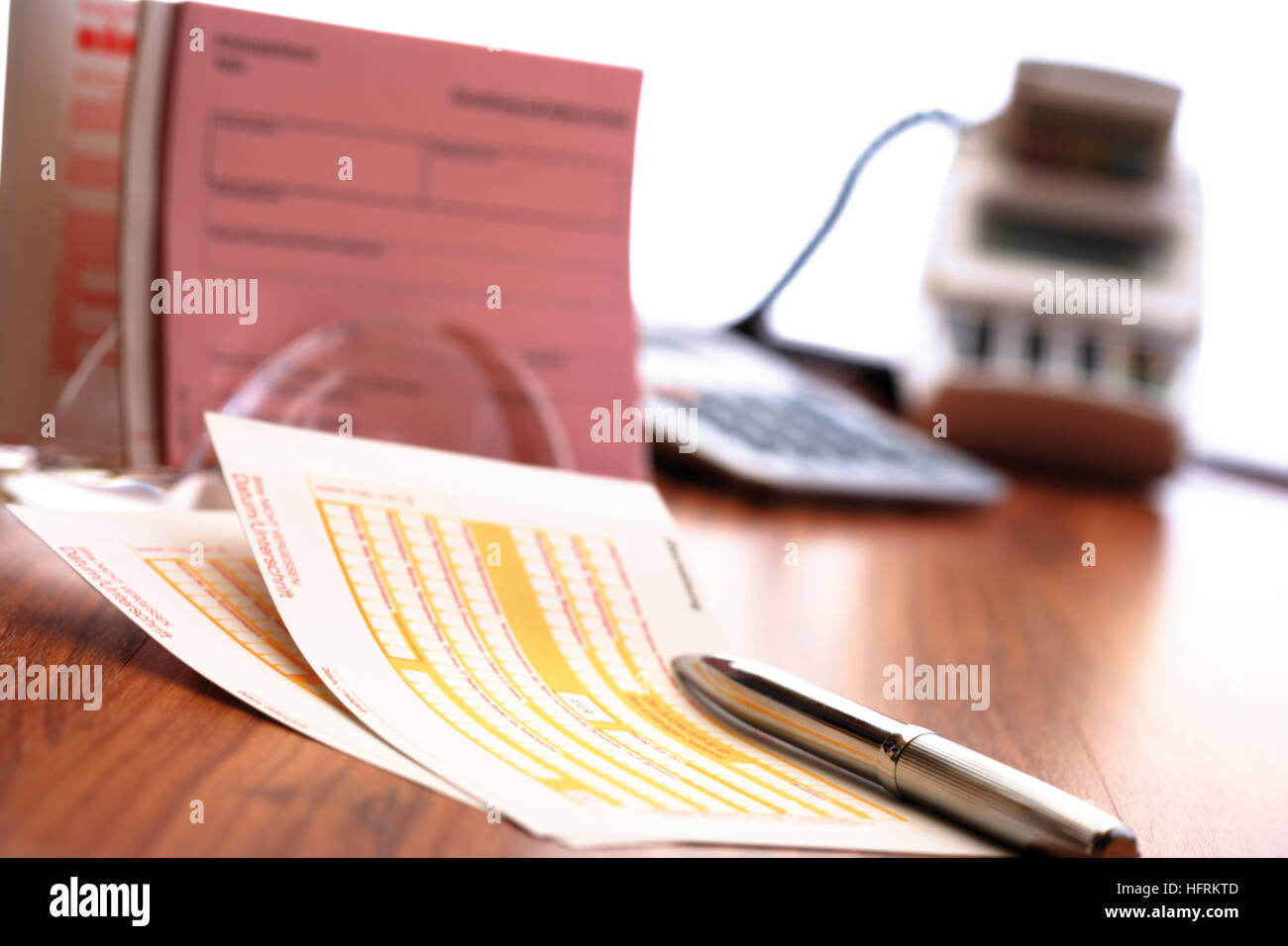 Funds transfer form and a pen, more forms in background Stock Photo - Alamy