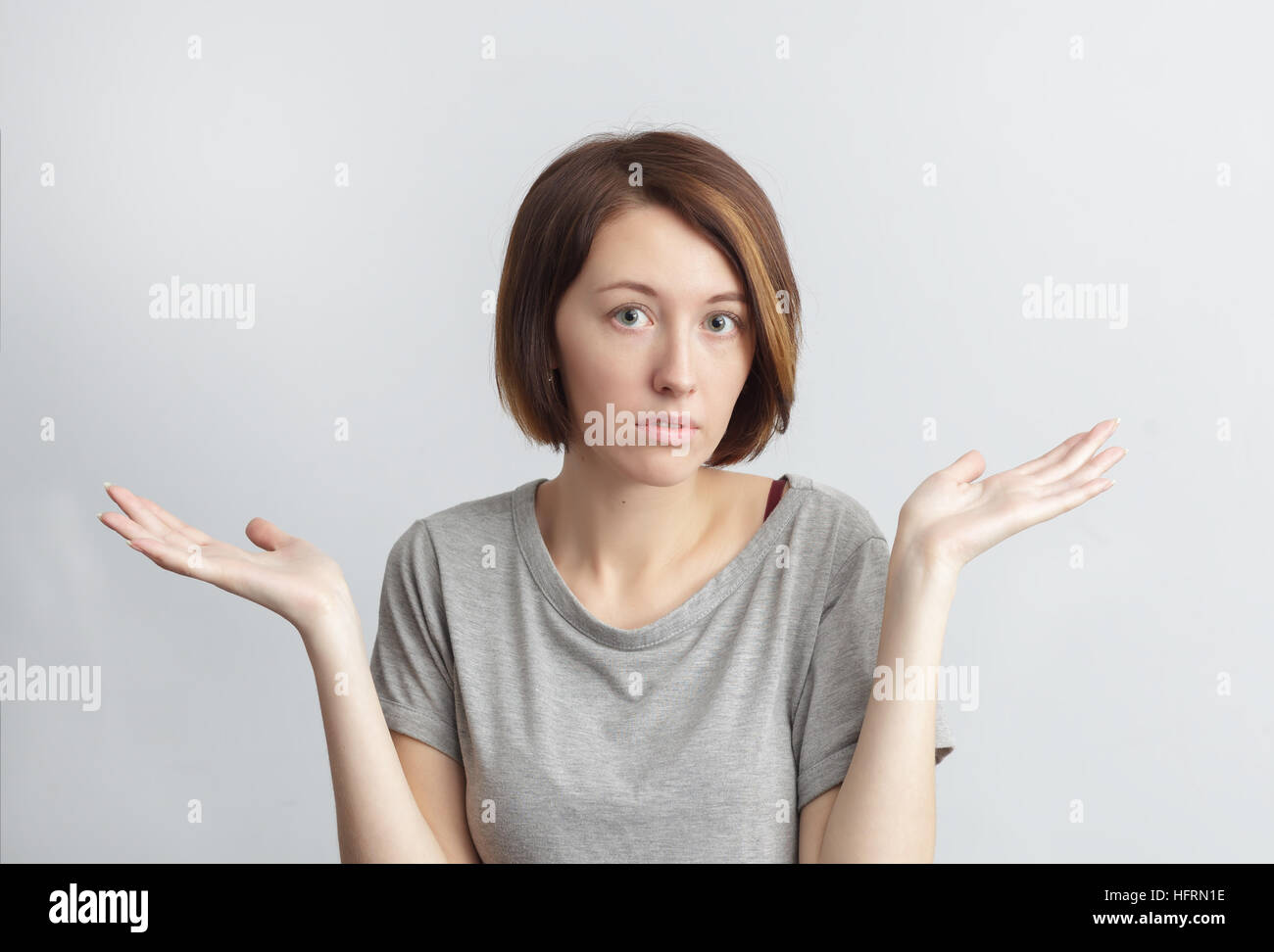 Portrait of unsure young woman Stock Photo - Alamy
