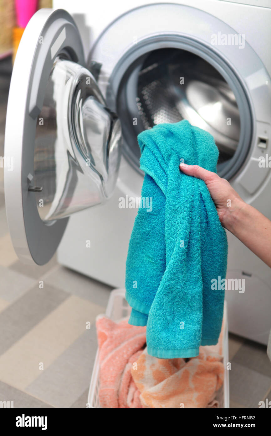 woman loading color clothes from washing machine Stock Photo - Alamy