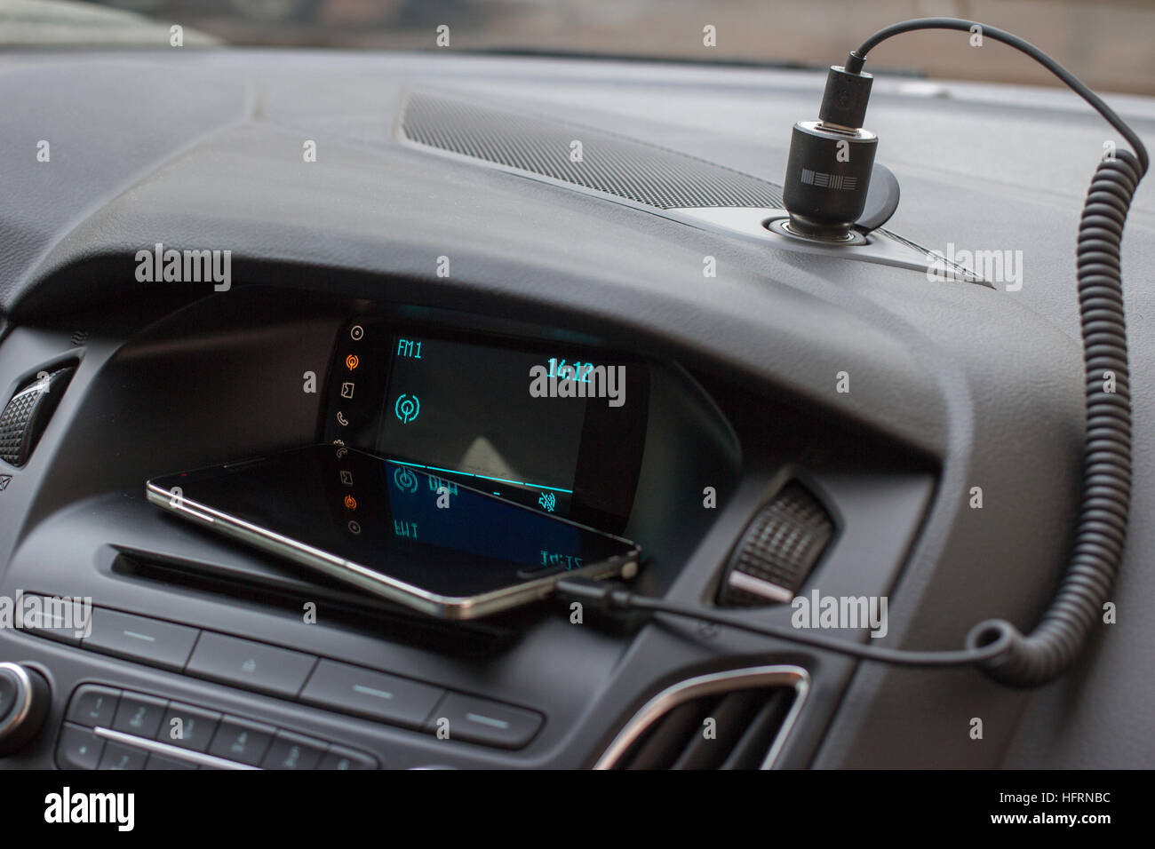 Modern car interior with smart phone on charge Stock Photo - Alamy
