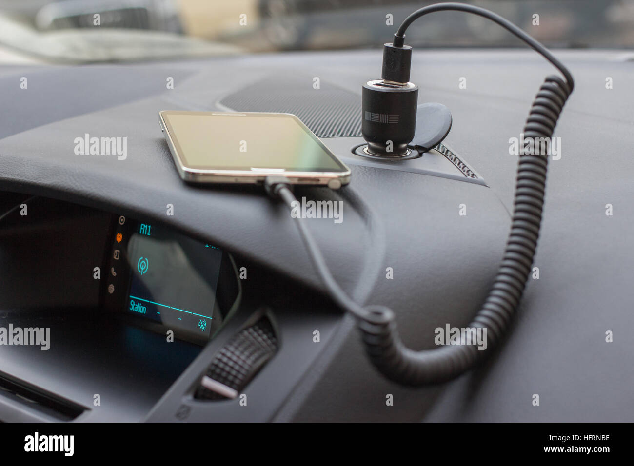 Modern car interior with smart phone on charge Stock Photo - Alamy