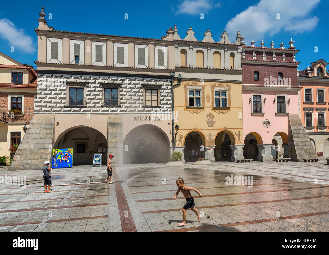 Kids playing at water hose on a hot summer day, burgher houses Nos. 19 ...