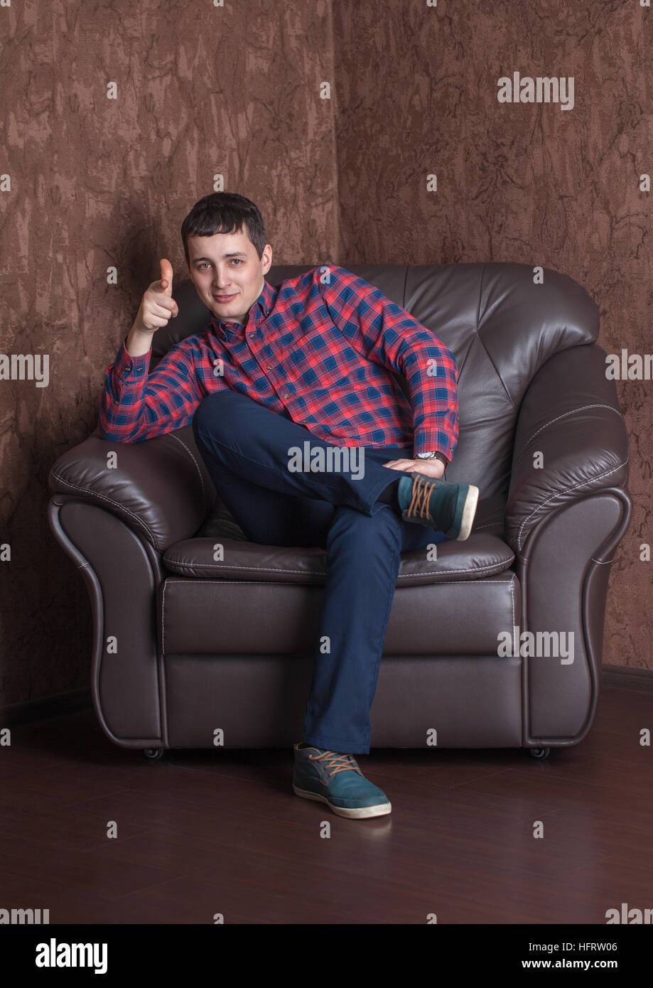 Young successful guy sitting on a leather armchair. Cool Stock Photo ...