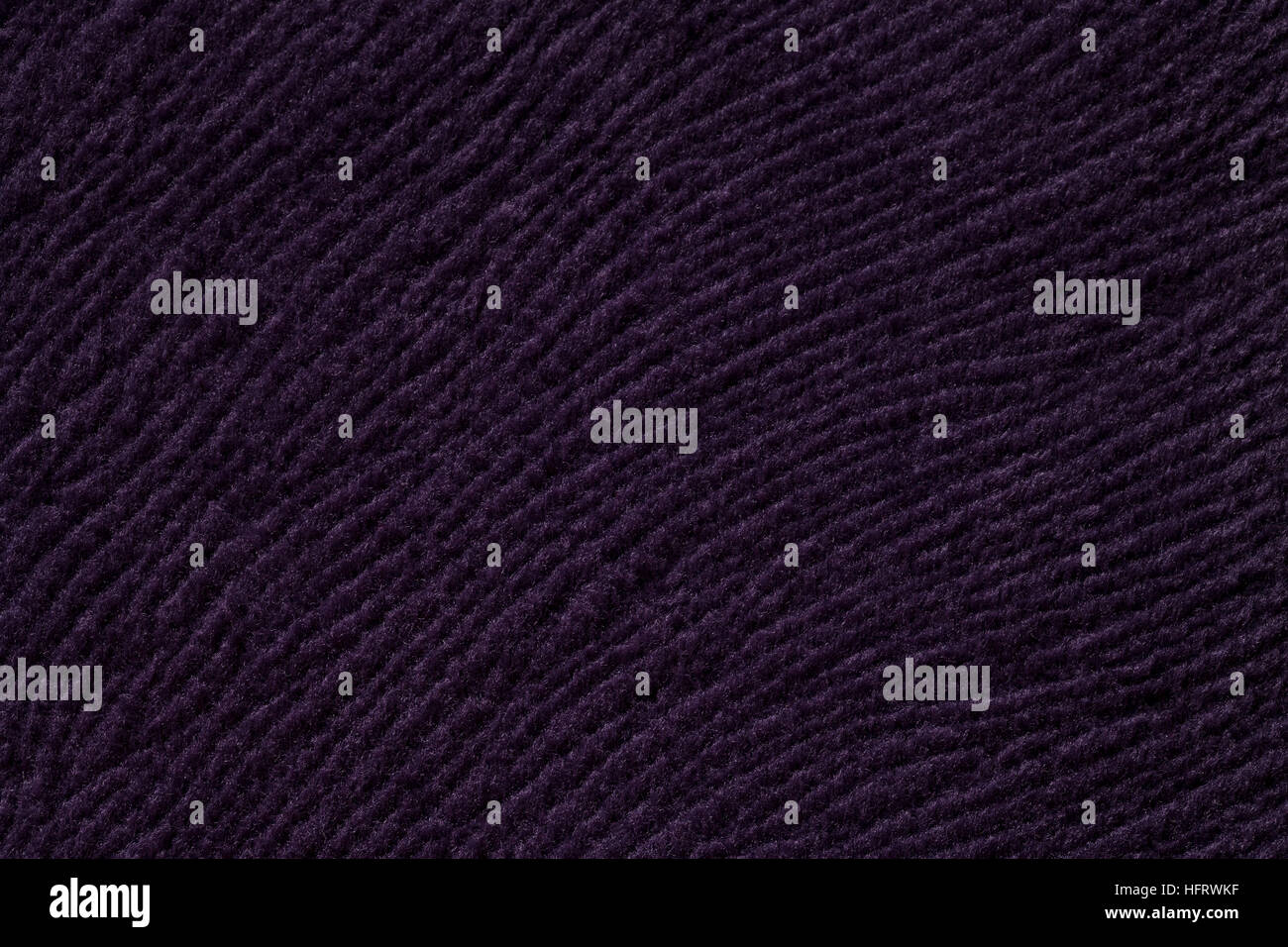 Dark purple background from a soft wool textile material closeup ...