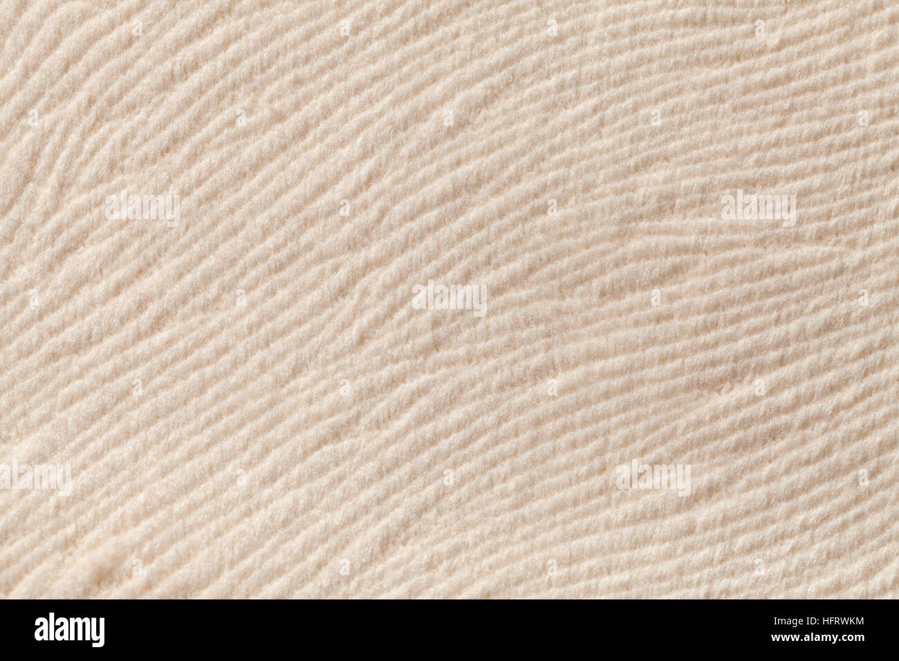 Light beige background from a soft wool textile material closeup ...