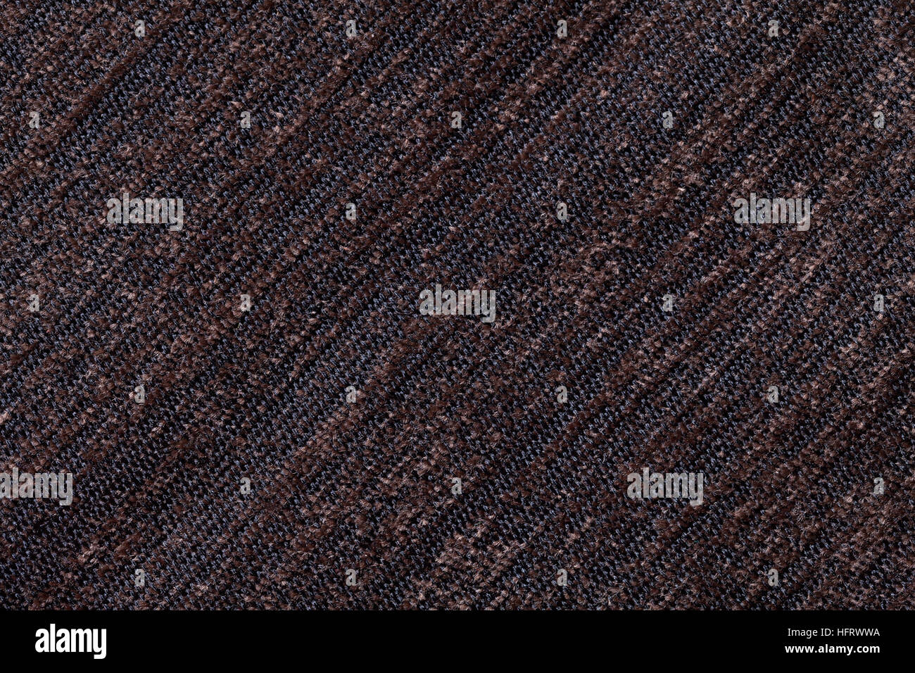 Dark brown background of a knitted textile material with diagonal ...