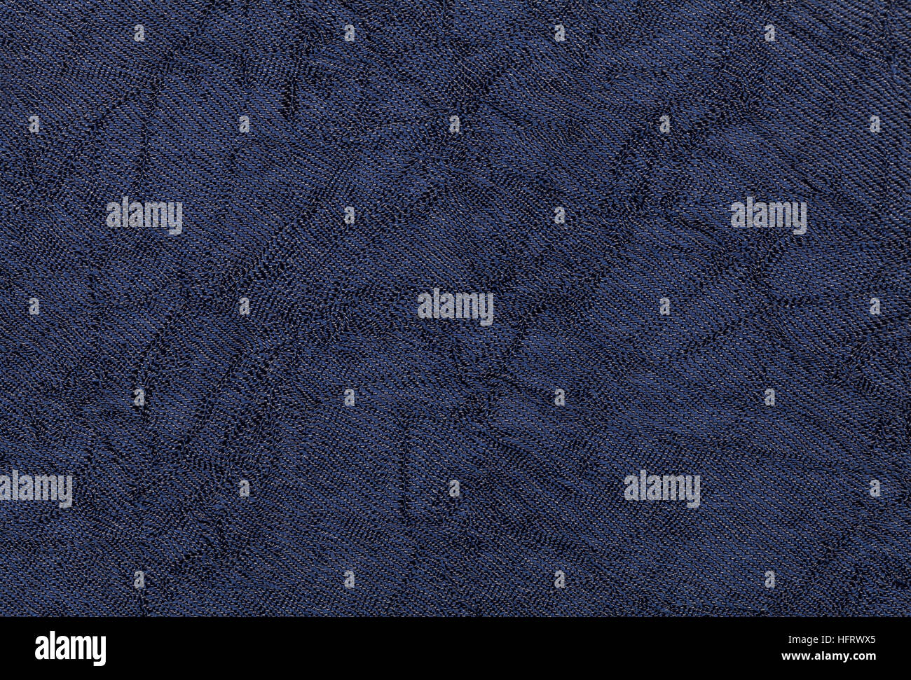 Dark blue wavy background from a textile material. Fabric with natural texture clousup ...