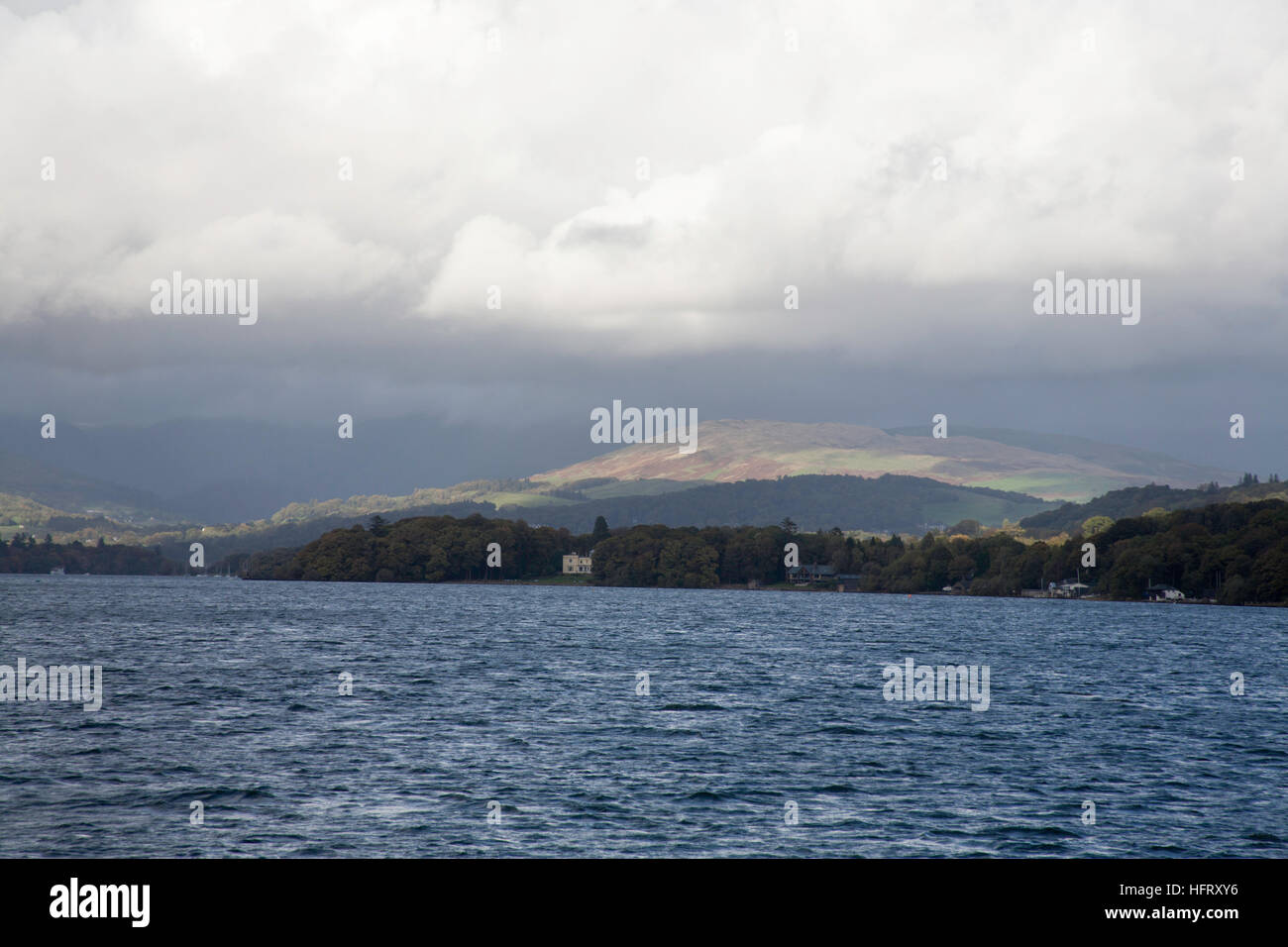 Storm clouds passing across the mountains to the north of Windermere ...