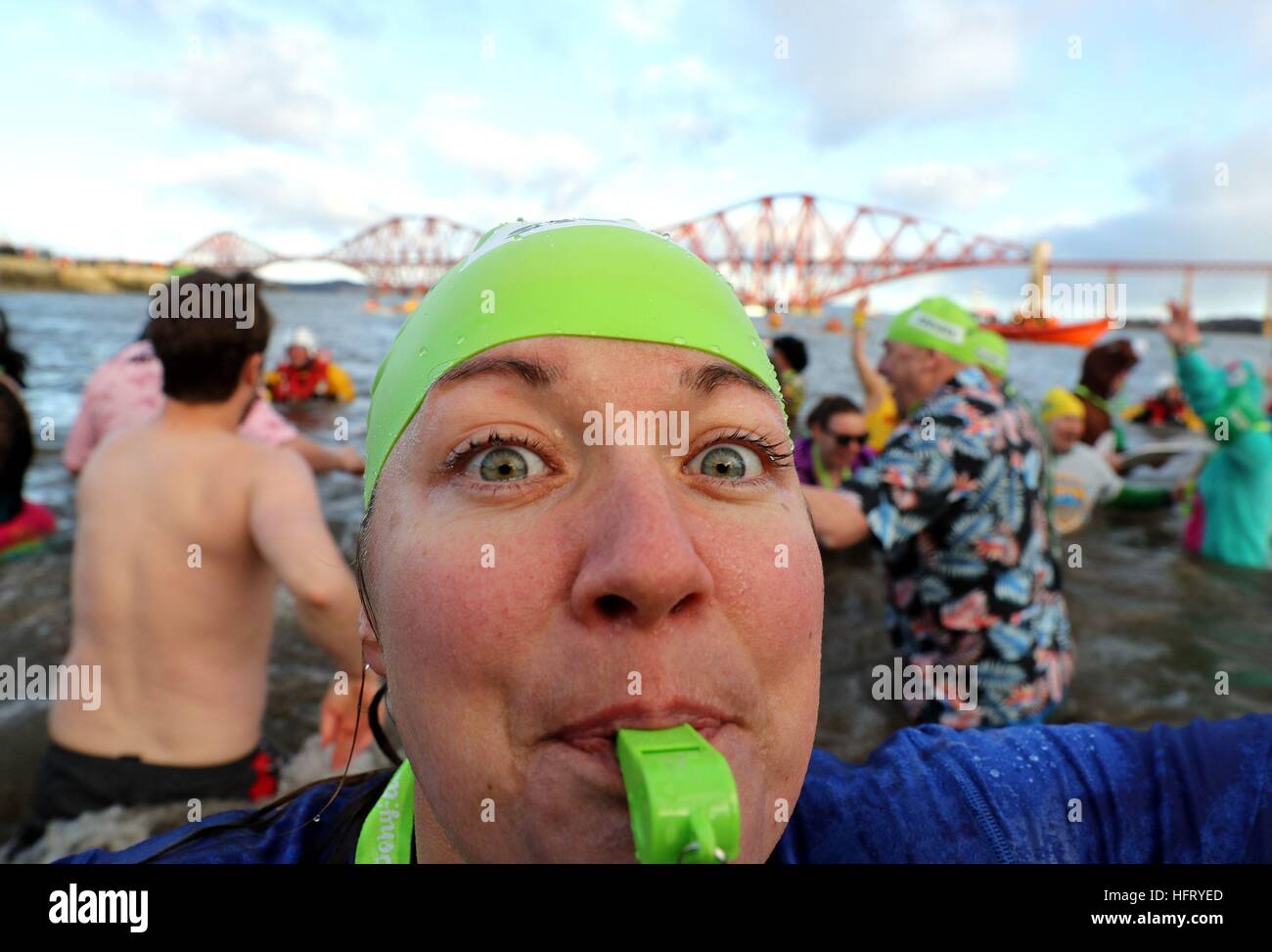 Swimmers take part in the Loony Dook New Year's Day dip in the Firth of ...