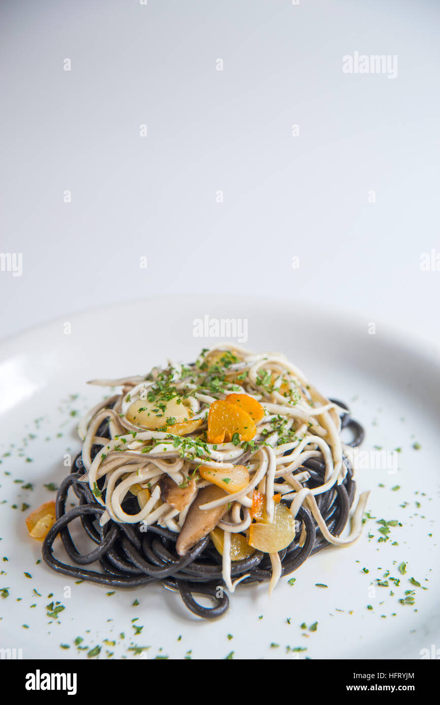 Black spaghetti with eels, garlic and parsley Stock Photo - Alamy