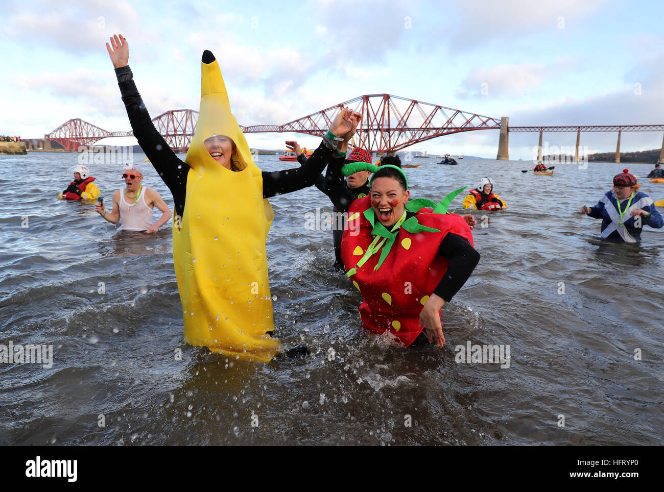 Swimmers take part in the Loony Dook New Year's Day dip in the Firth of ...