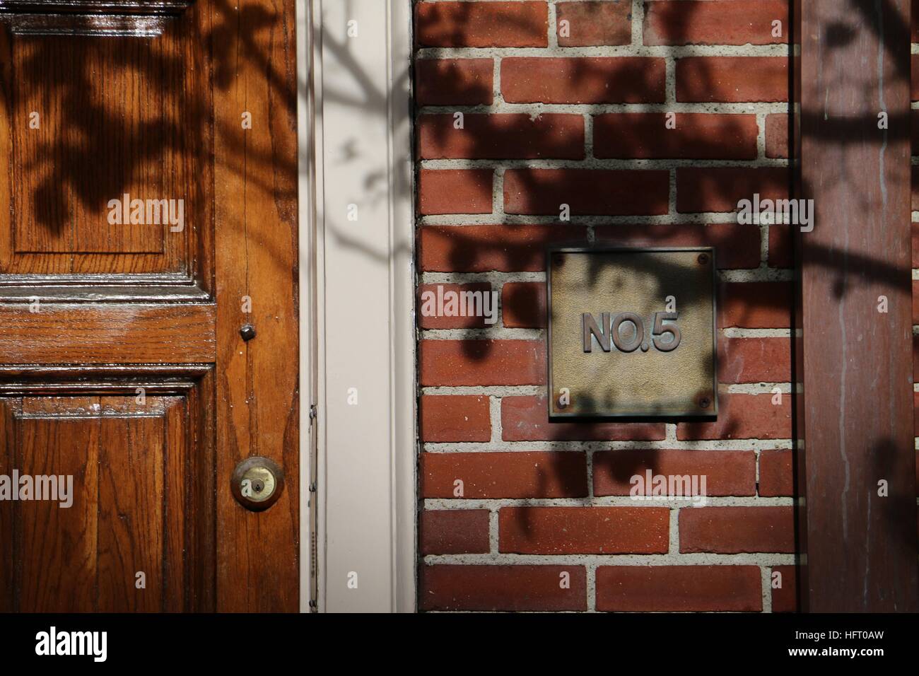 Address on brick wall with shadow Stock Photo - Alamy