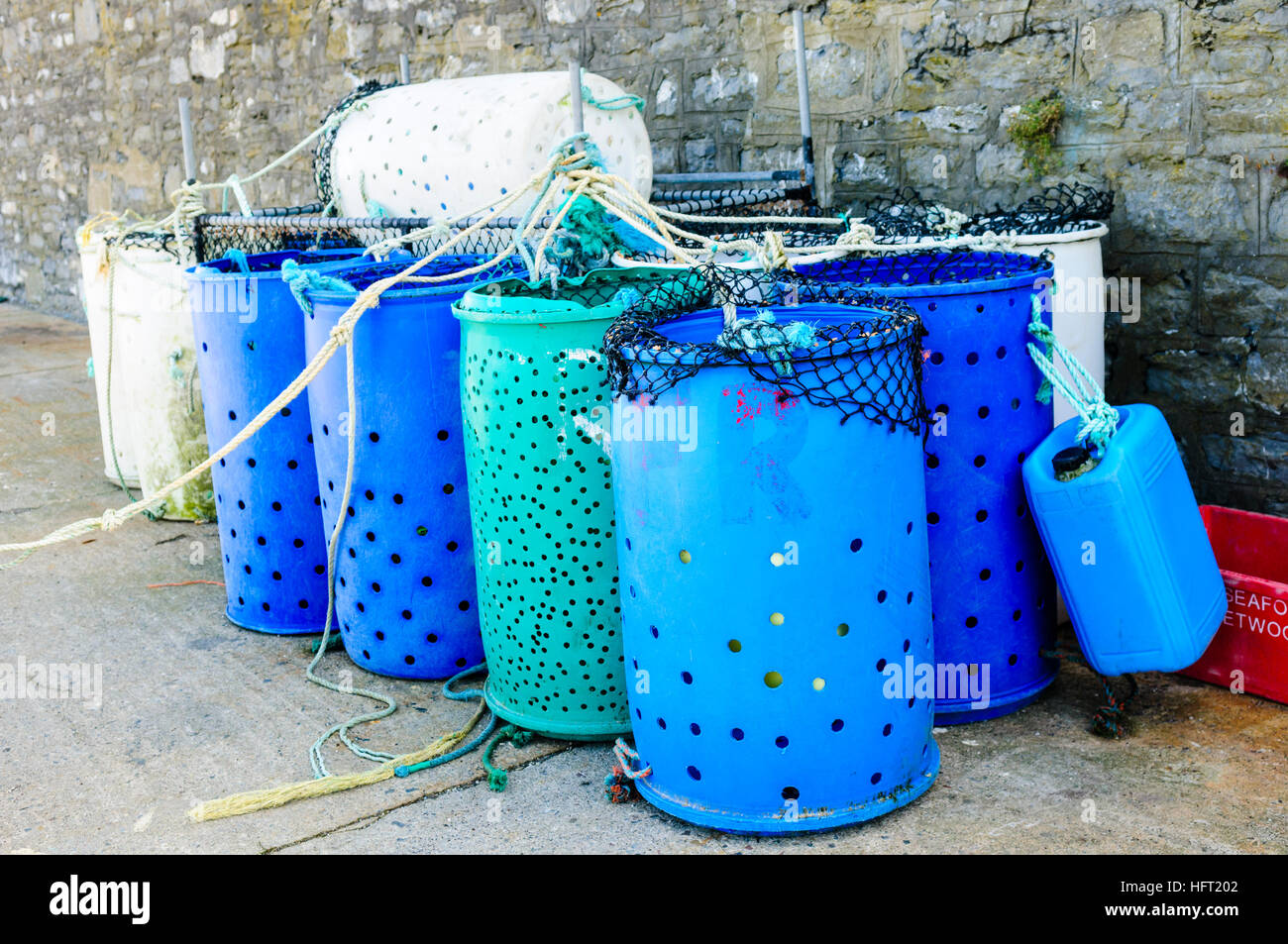 Barrels used for sorting fish by trawler fishermen at a harbour Stock ...