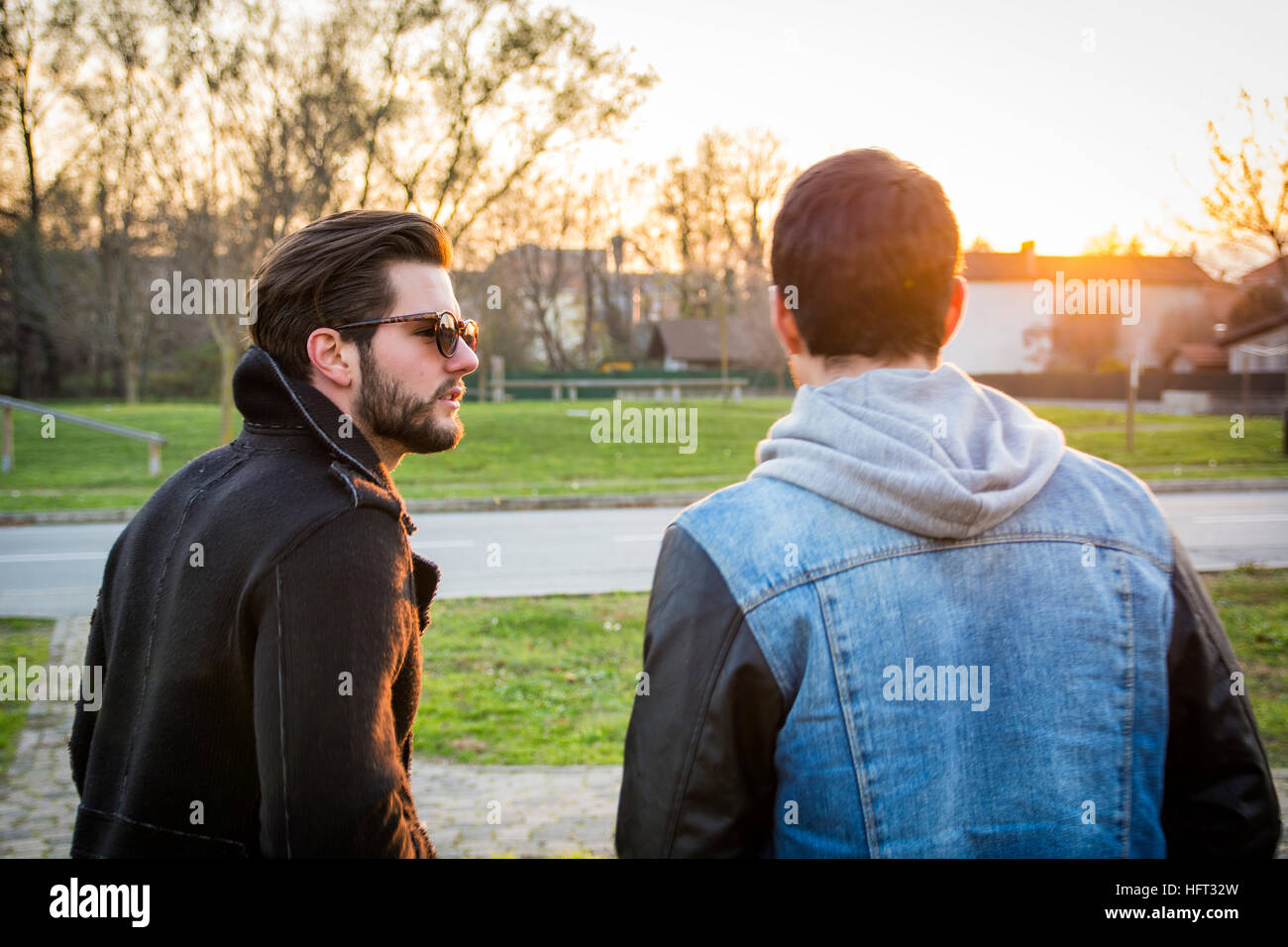 Two handsome young men, friends, in a park Stock Photo - Alamy