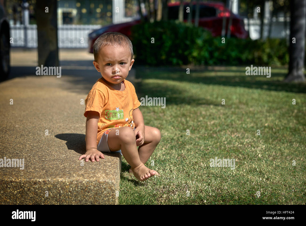Child alone outside in the garden Stock Photo - Alamy