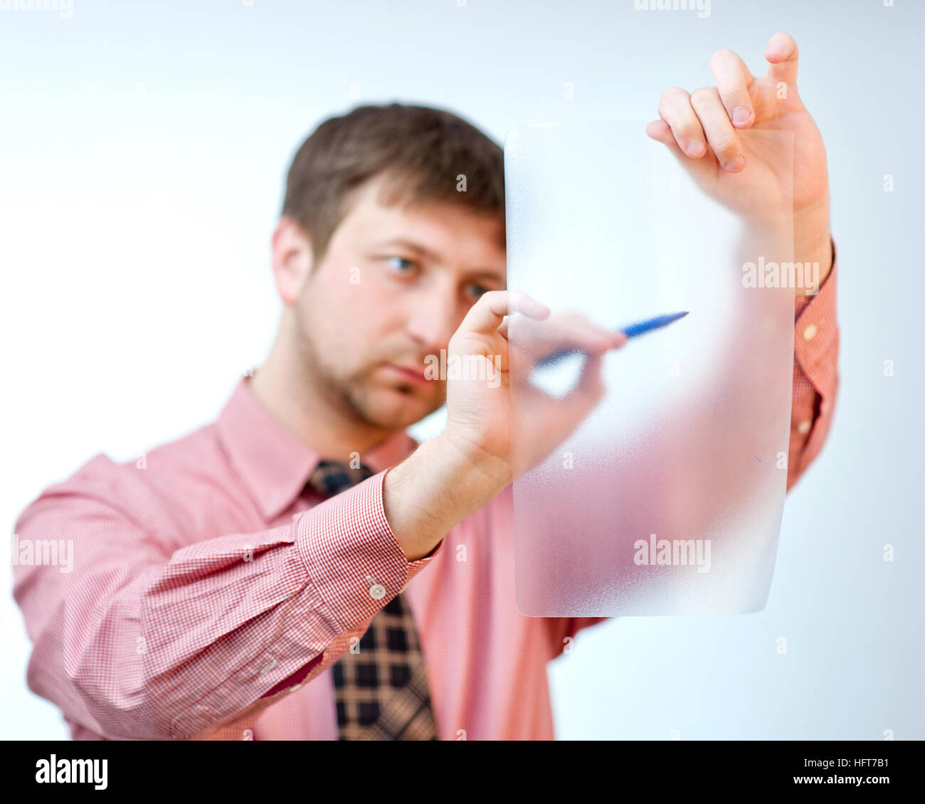 male showing something on transparent paper Stock Photo - Alamy