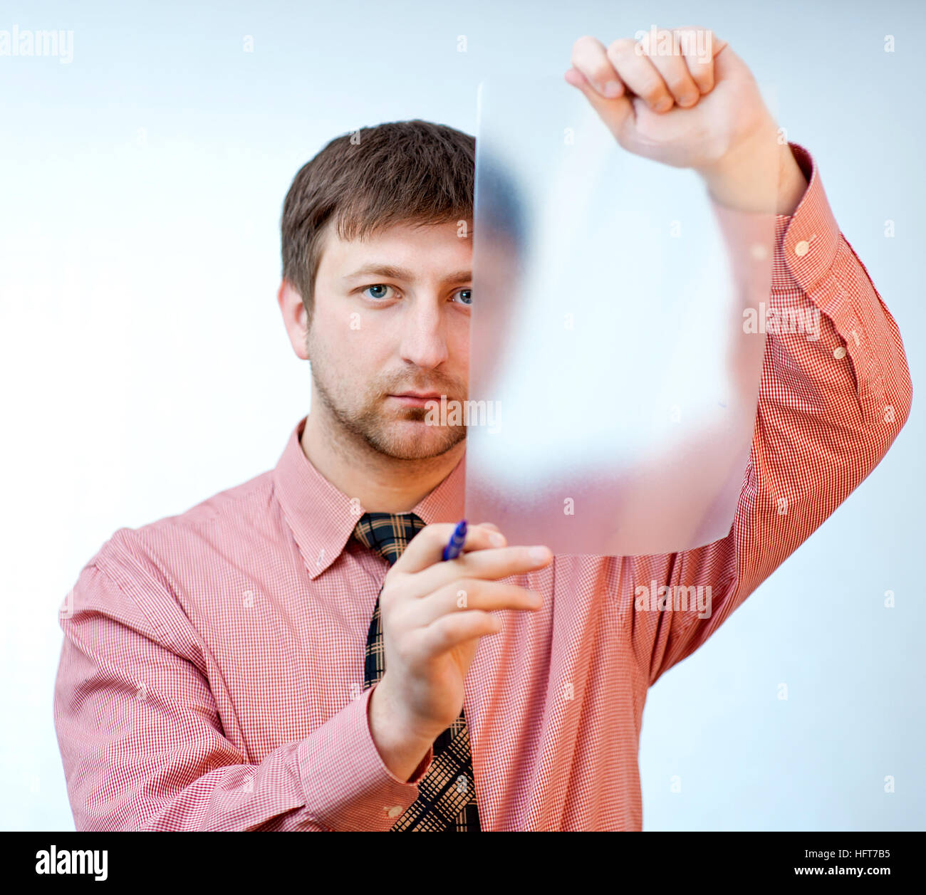 male showing something on transparent paper Stock Photo - Alamy