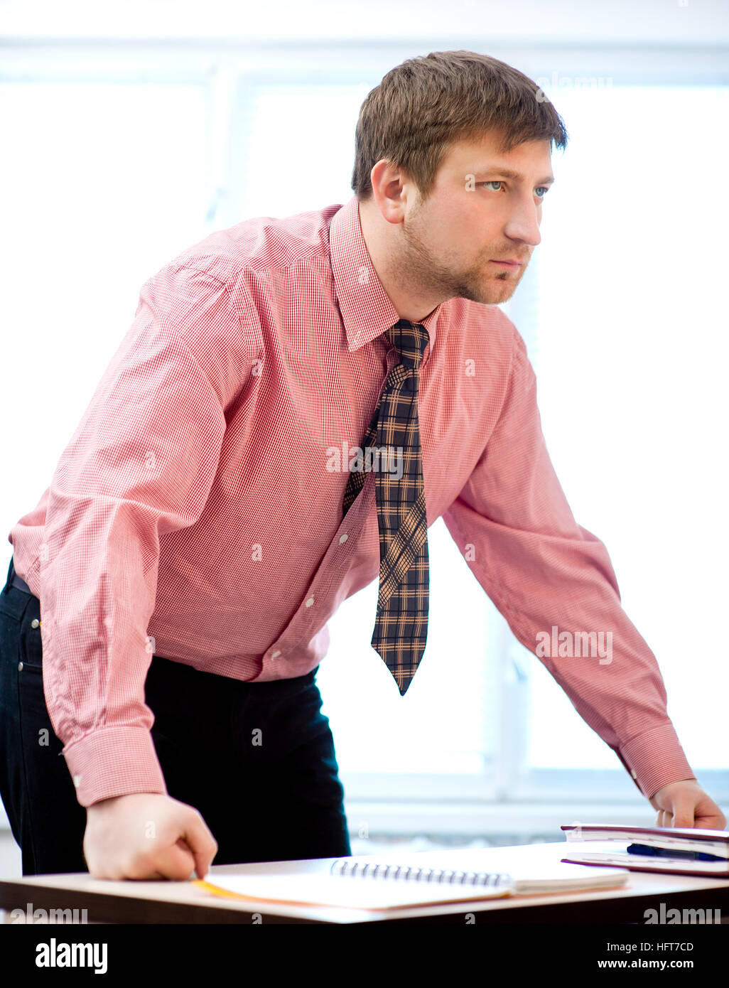 Angry businessman leans on the table Stock Photo - Alamy