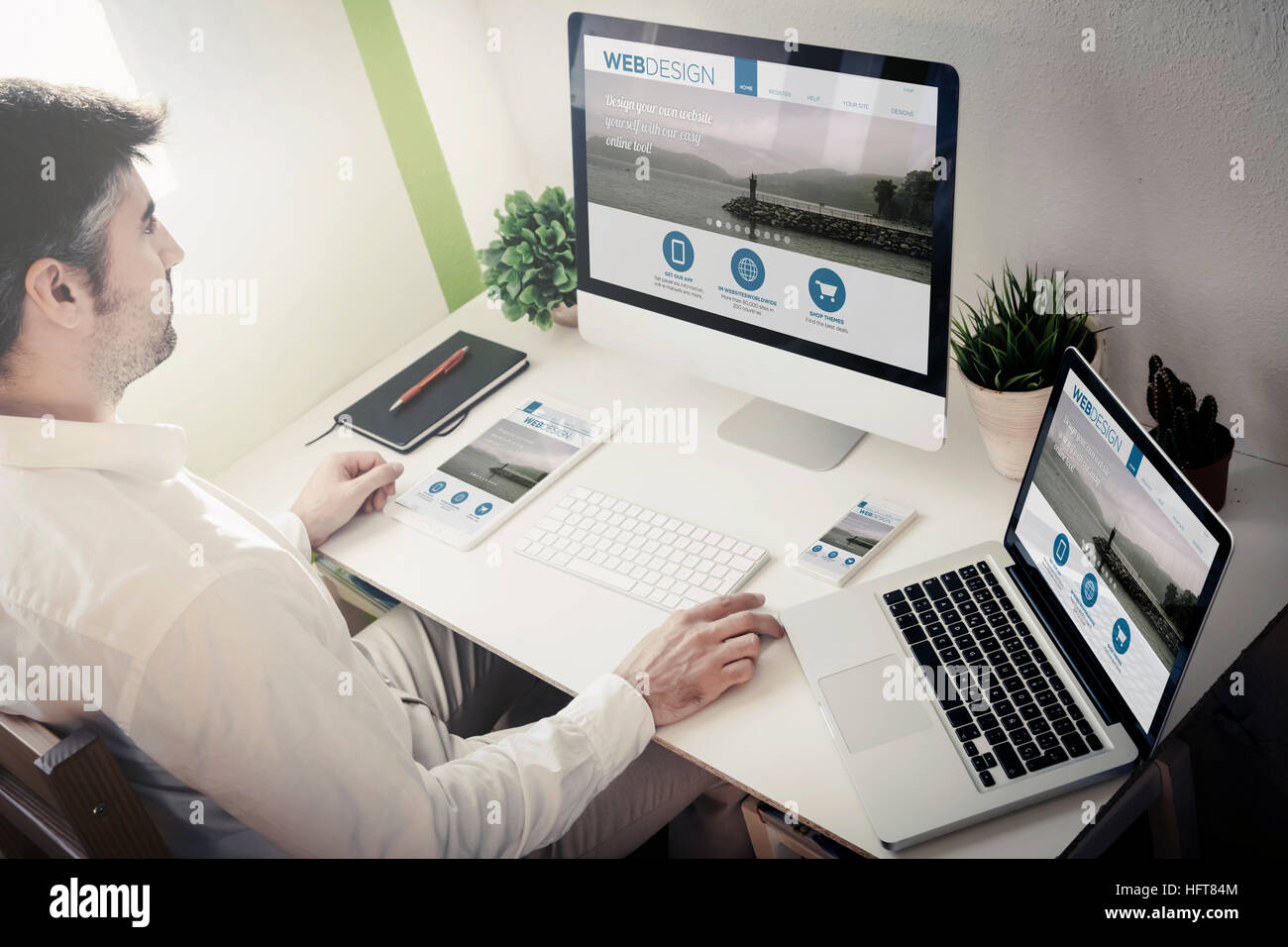 man working with devices with responsive web design. All screen ...