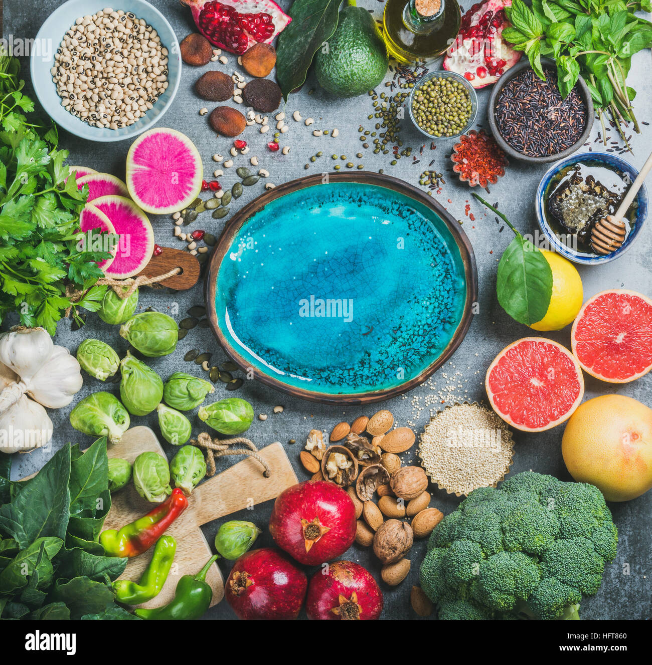 Healthy food over grey background, bright blue plate in center Stock ...