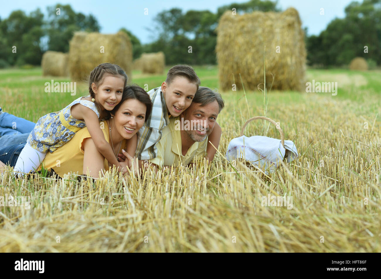happy family at field Stock Photo - Alamy
