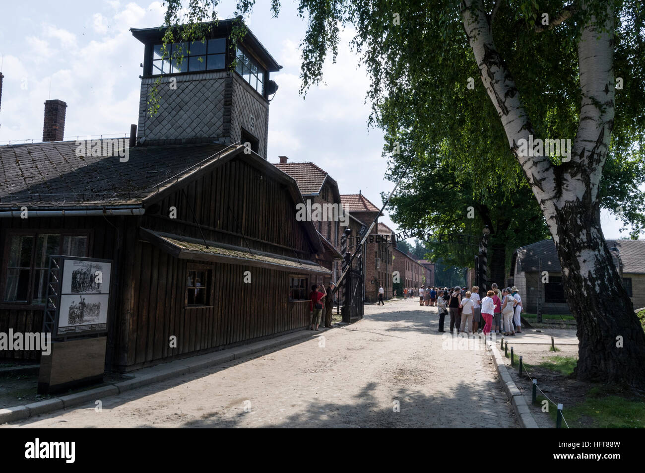 Visitors entering the main infamous gates, Arbeit Macht Frei (Work ...