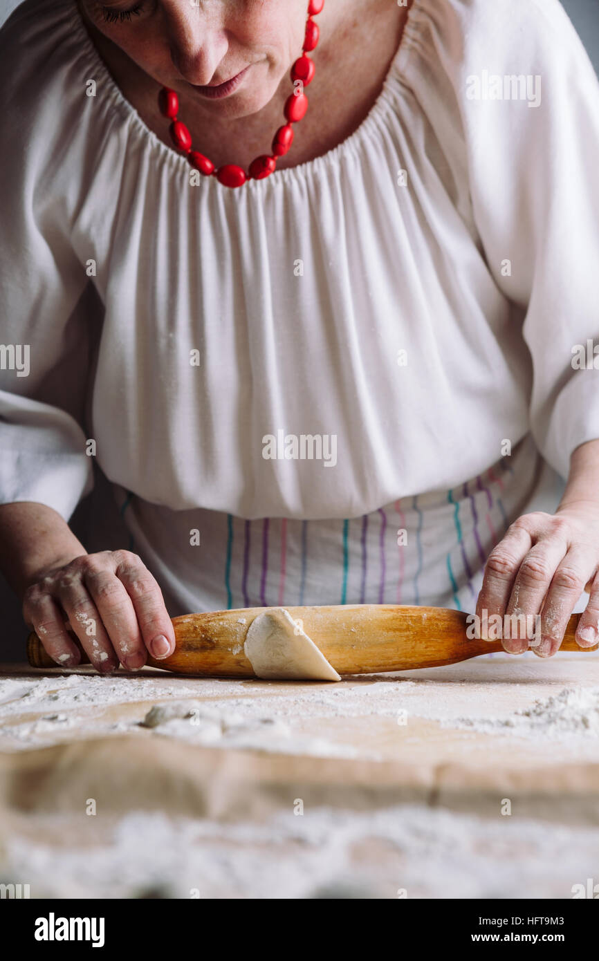 Making meat dumpling with wooden rolling pin Stock Photo - Alamy