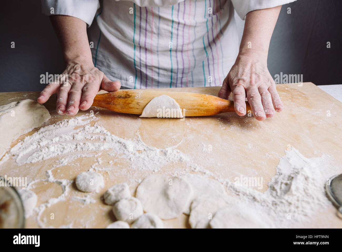 Making meat dumpling with wooden rolling pin Stock Photo - Alamy