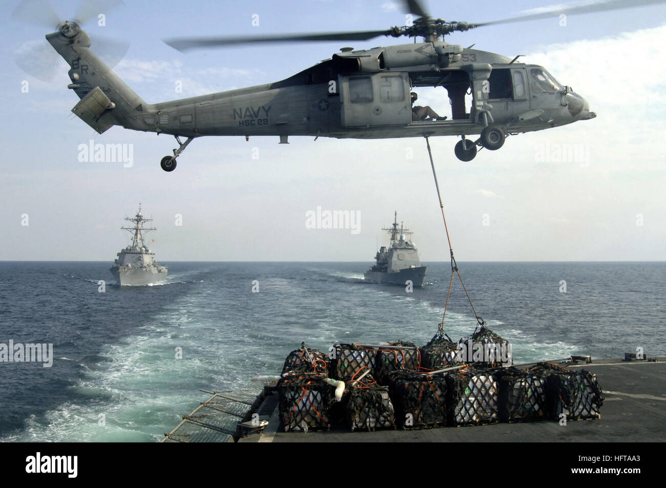 061120-N-8148A-014 A MH-60S Nighthawk helicopter lifts cargo nets of ...