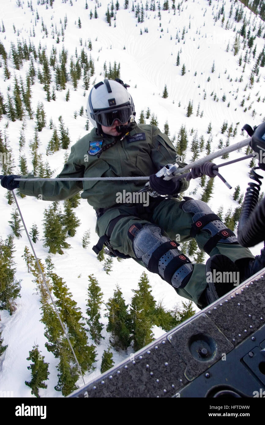 Helicopter in-flight rescue crew conducts rappel training from an MH ...