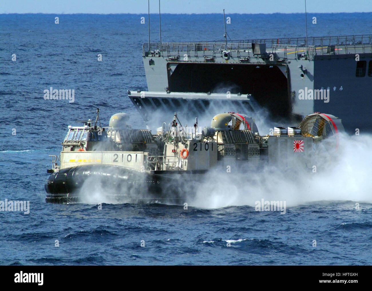 A JMSDF LCAC conducts operations alongside JDS Ohsumi (LST 4001) during ...