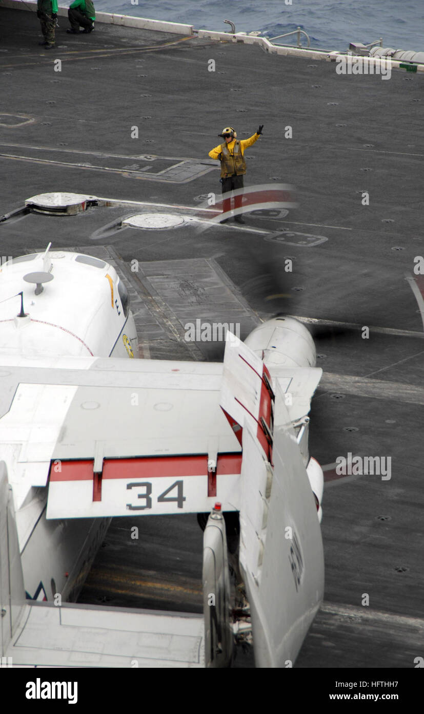 An aircraft handler directs a C-2A Greyhound from Fleet Logistics ...
