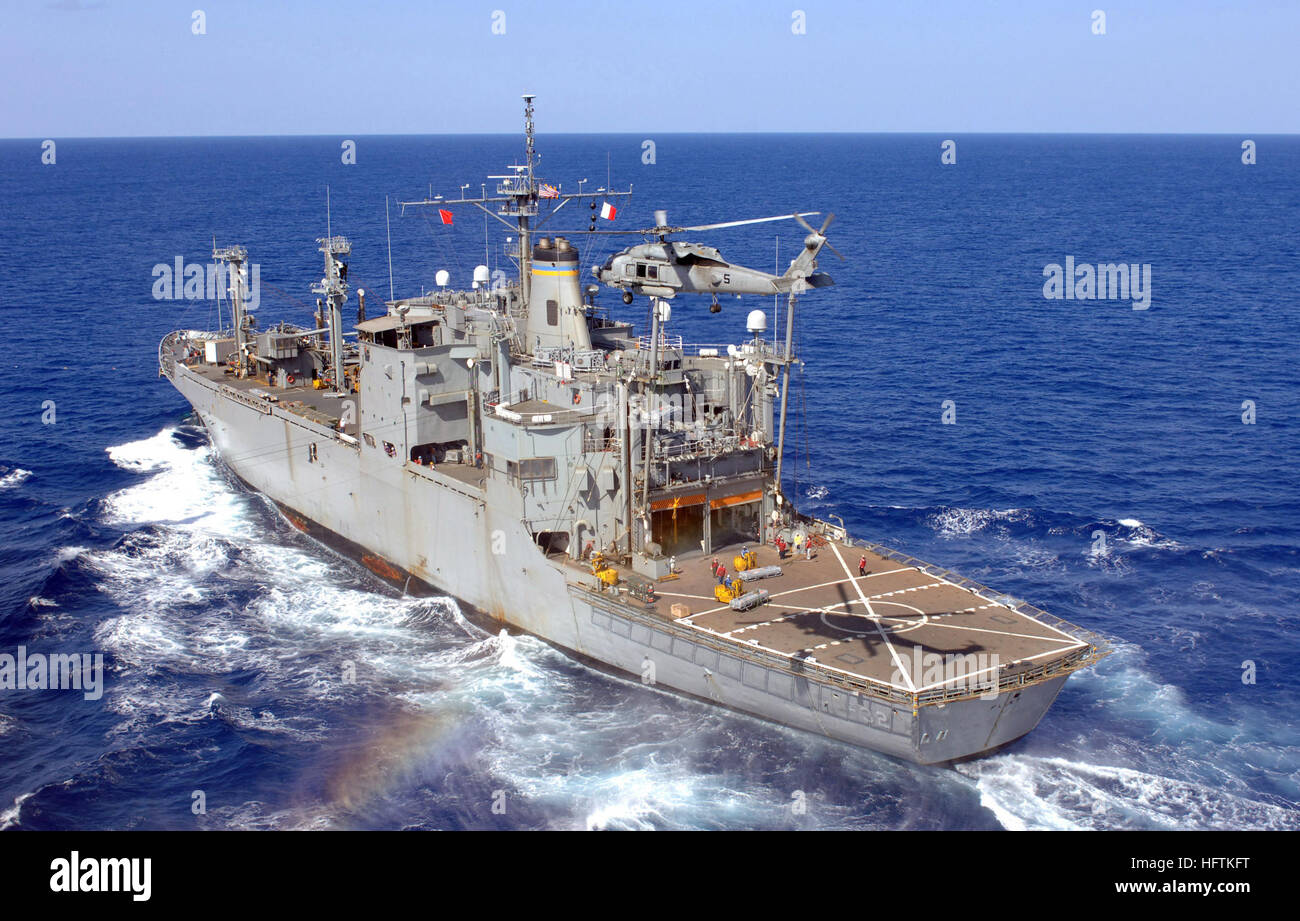 A helicopter from HS-4 Black Knights clears the flight deck of USNS ...
