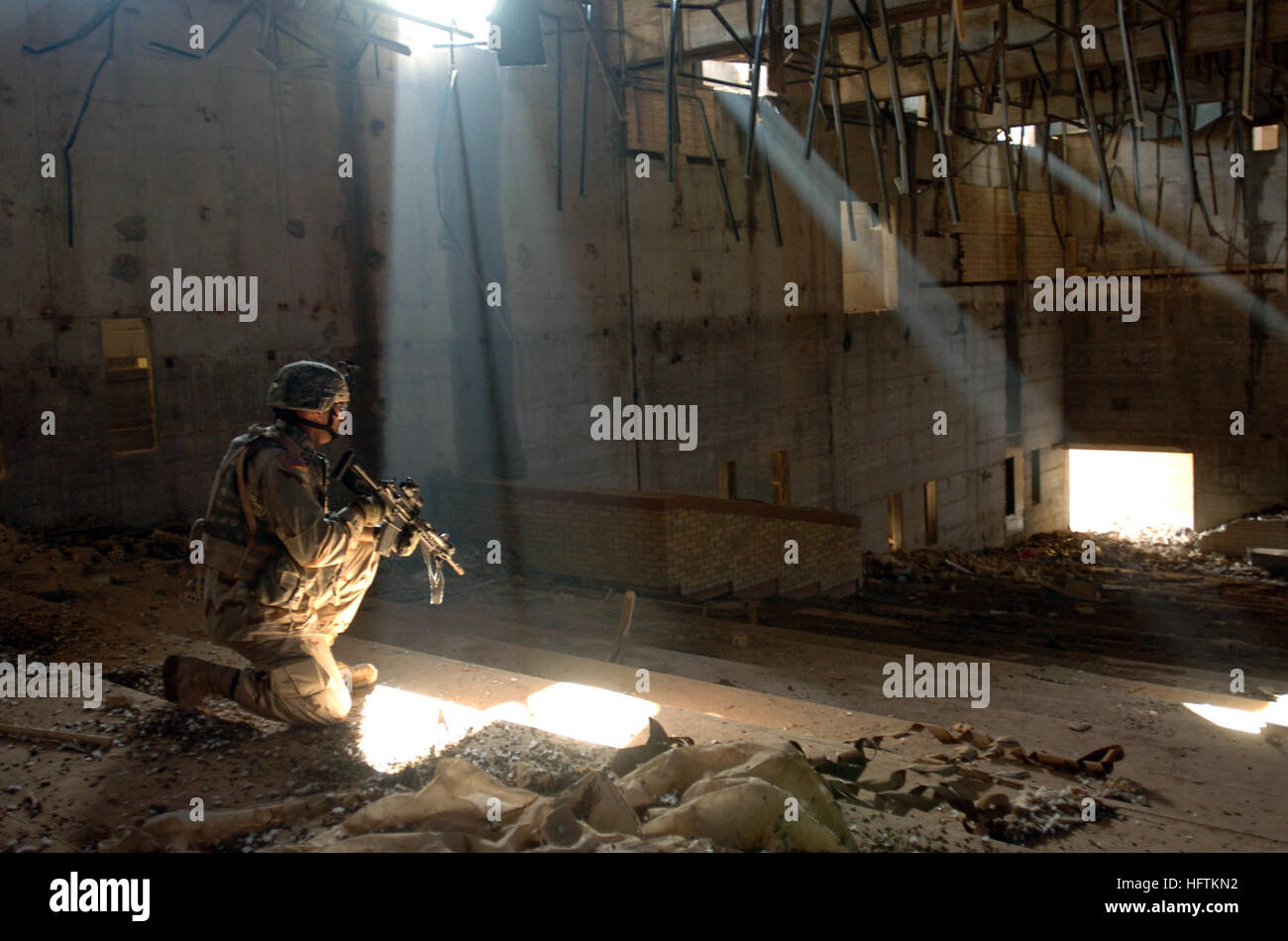 U.S. Army 2nd Lt. Amos Fox secures a building in a weapons compound in ...