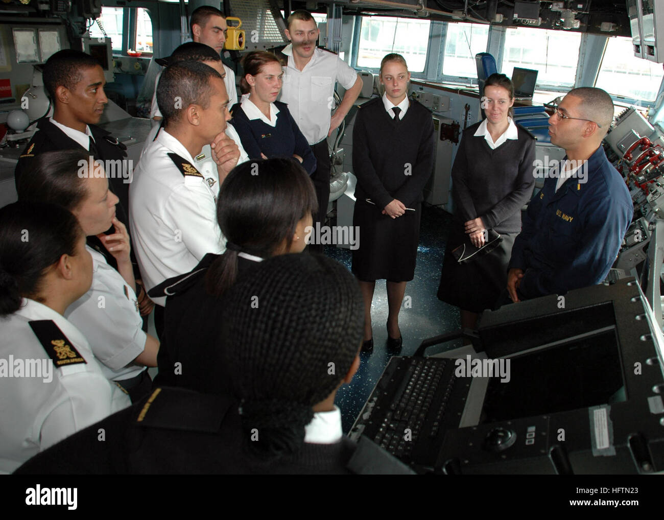 Ensign Jose Montanez of USS Arleigh Burke (DDG 51) gives a ship's tour ...