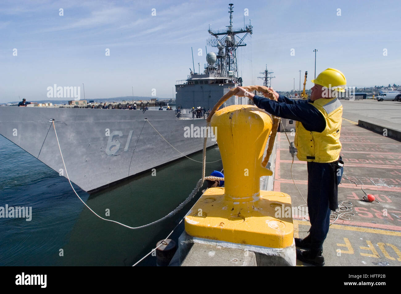 Boatswain's Mate aboard USS Shoup (DDG 86) secures mooring lines as ...