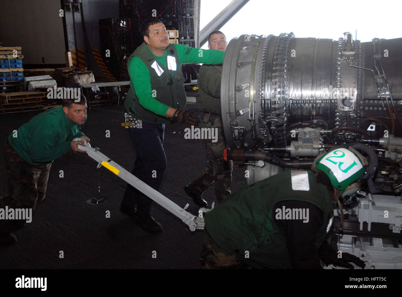 Sailors of VFA-41 move an F/A-18E Super Hornet engine on USS Nimitz ...