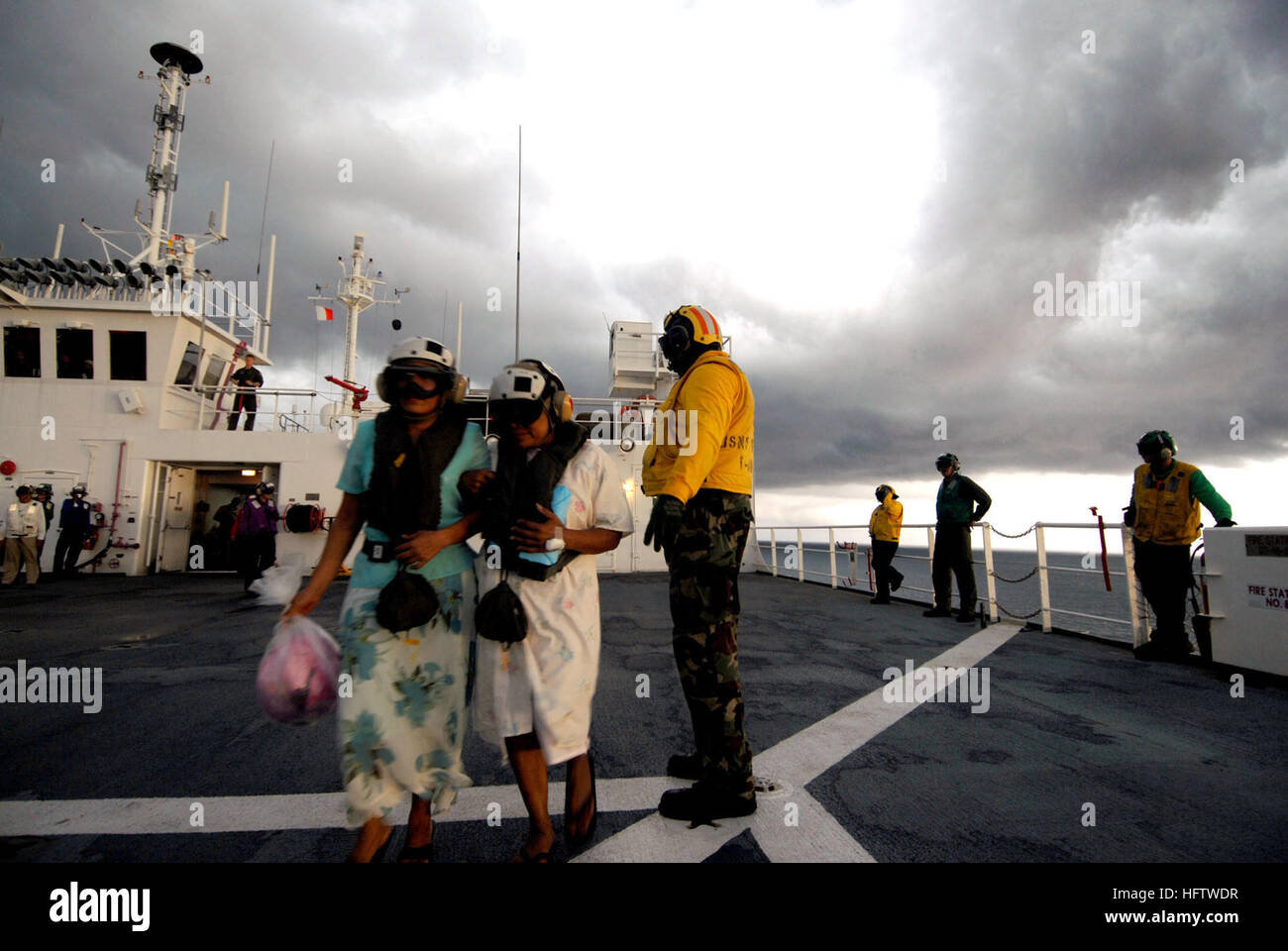 Aviation Boatswain's Mate (Handling) 1st Class directs patients on a ...