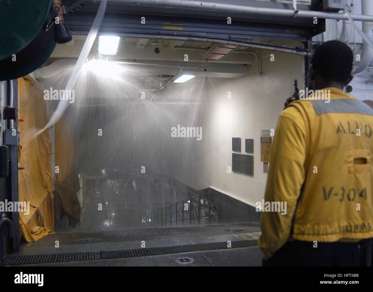 Aviation Boatswain's Mate Handler 2nd Class observes the sprinkler ...