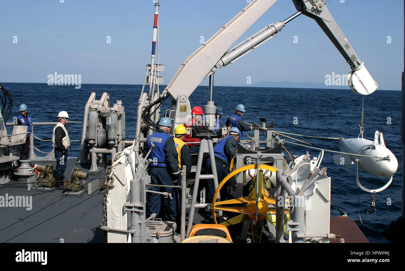 Sailors aboard mine countermeasures ship USS Patriot (MCM 7) lower a ...