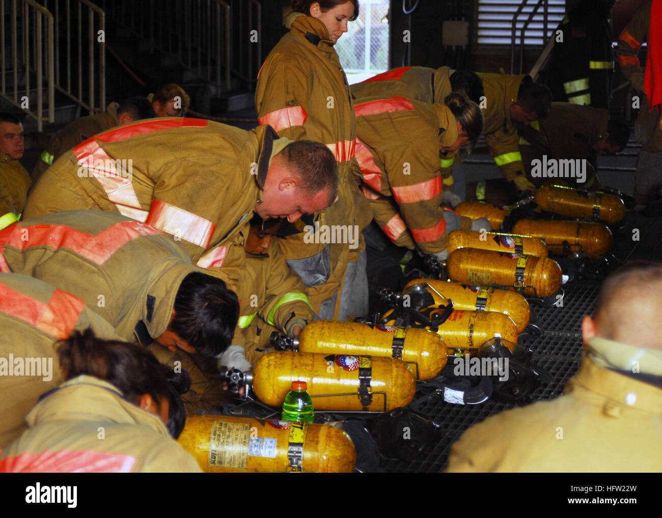 Sailors aboard USS Frank Cable (AS 40) prepare self-contained breathing ...