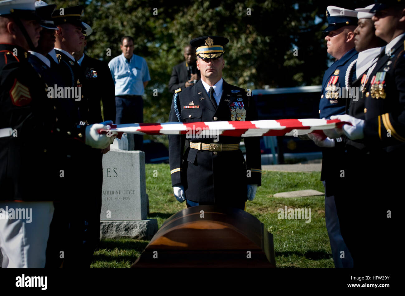 A joint service honor guard prepares to fold the national ensign during ...